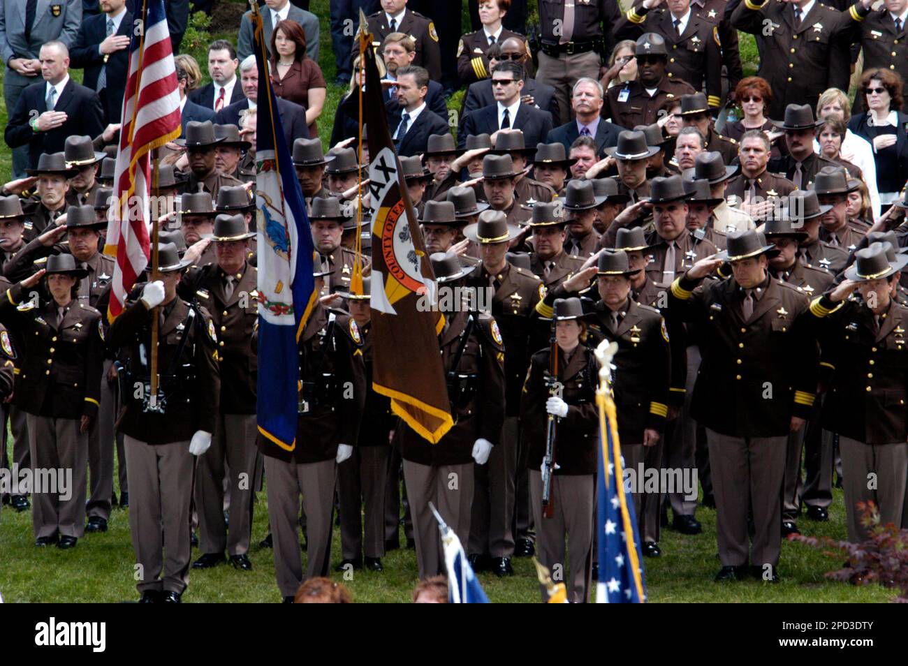 Fellow officers salute as the hearse carrying the casket of slain ...