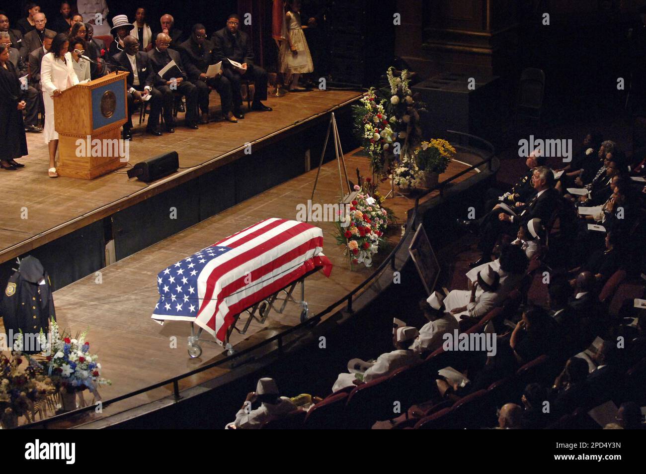 Phiana Wilcox, at podium left, speaks at the funeral for her father ...