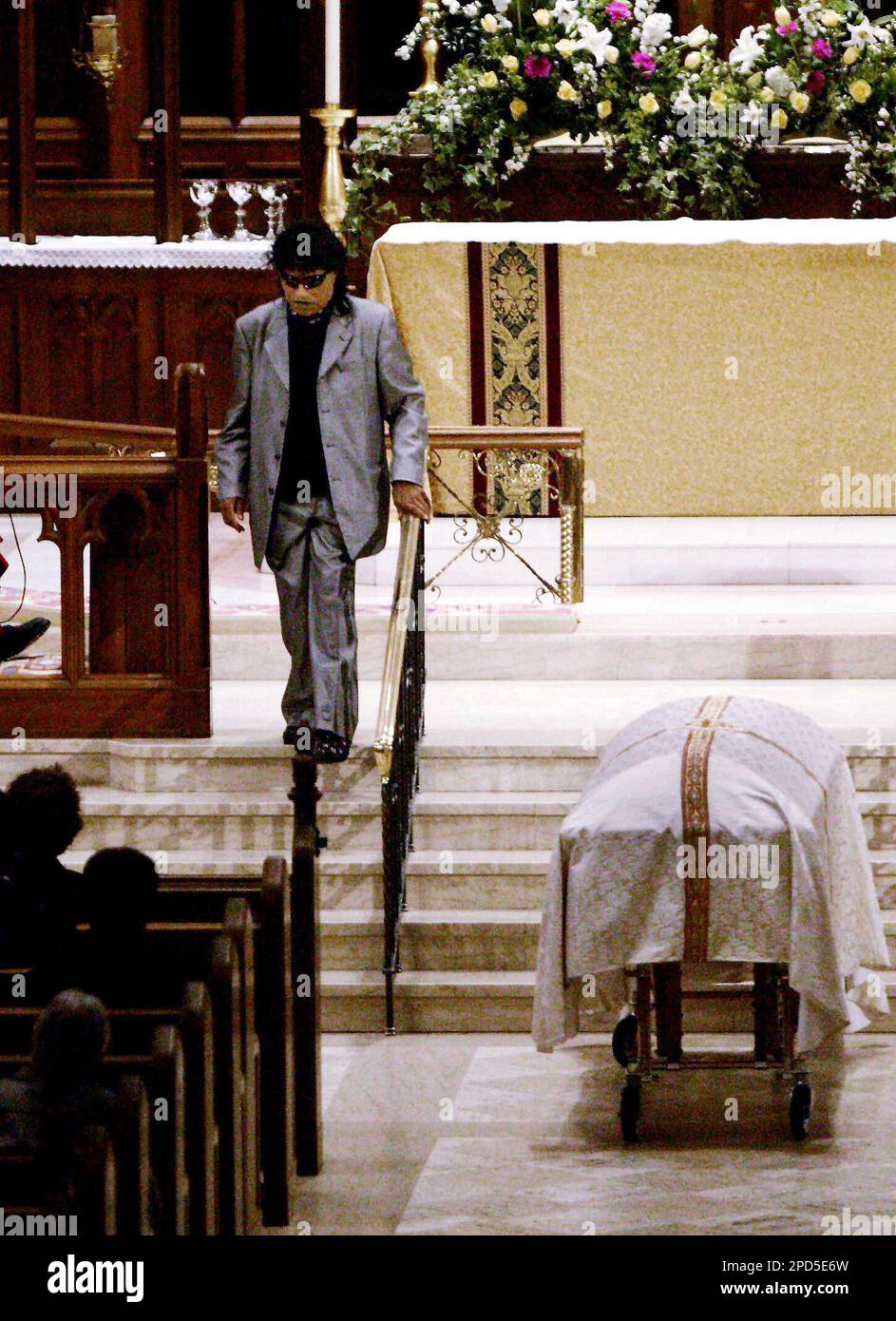 Rock legend Little Richard walks back to his seat after speaking at ...