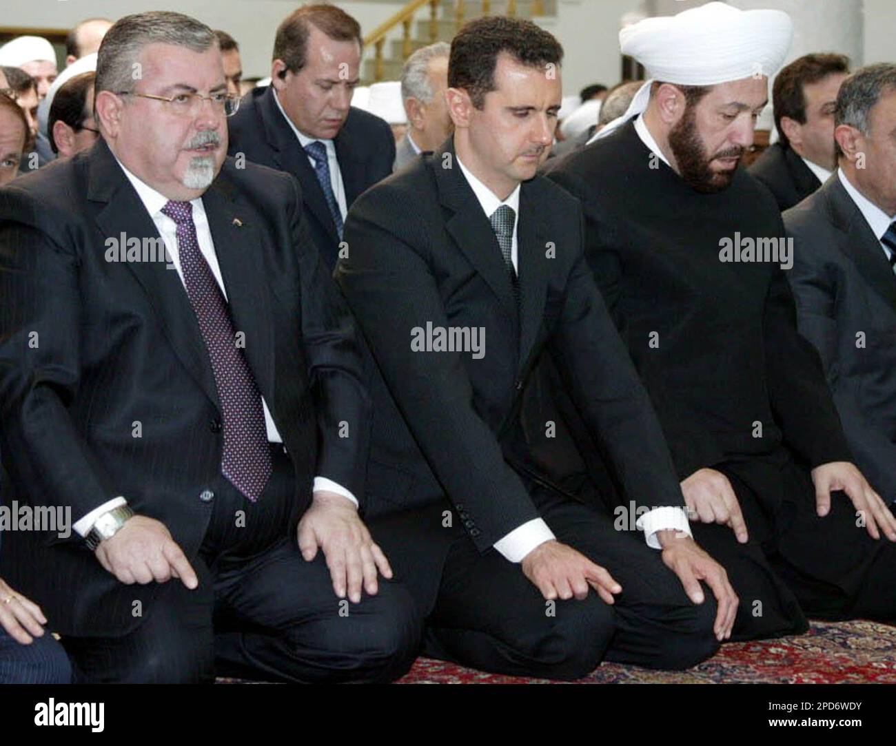 Syria's President Bashar Assad, centre, Syria's Grand Mufti Ahmad Badre ...