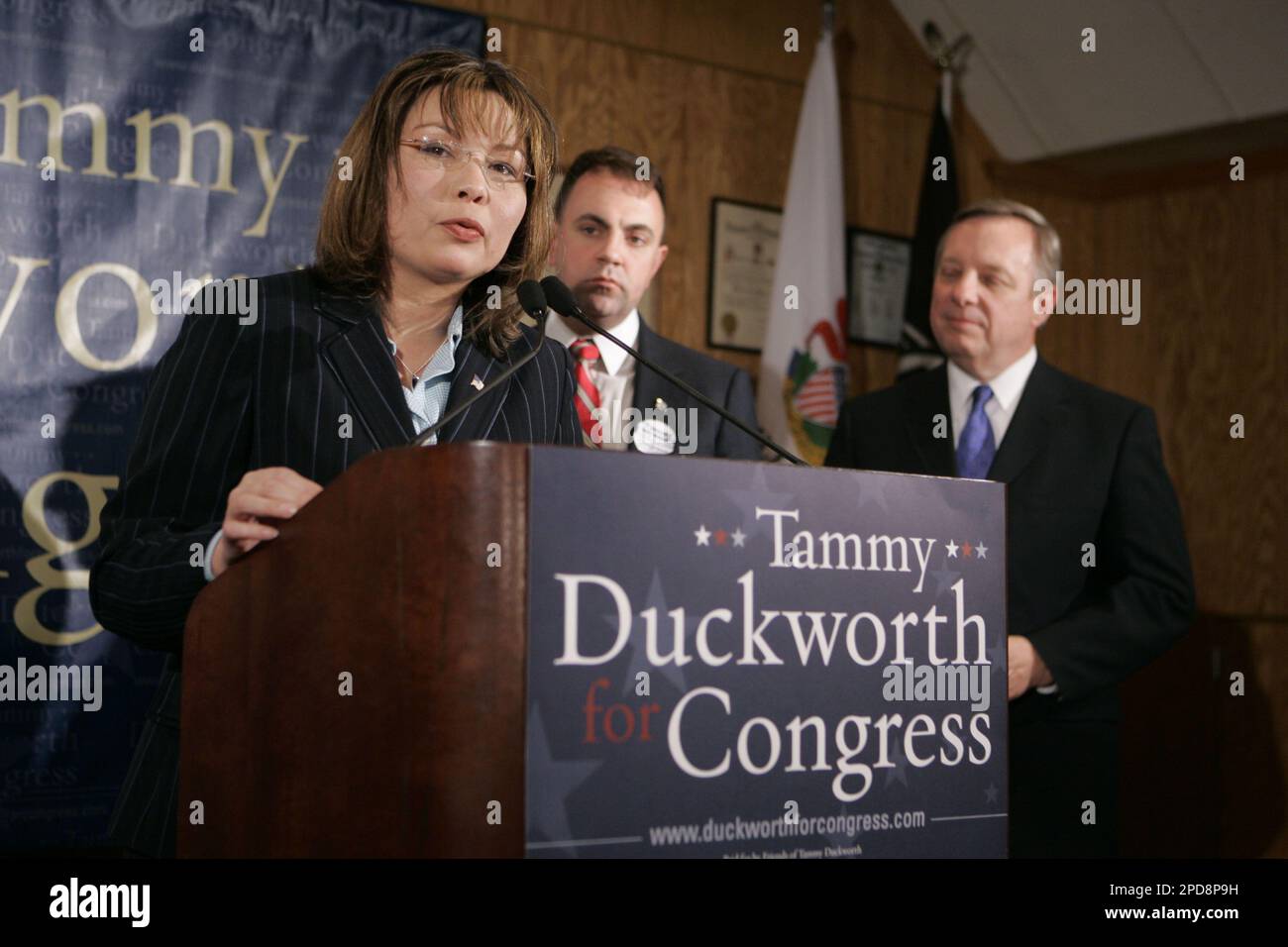 Tammy Duckworth, right, speaks to supporters as her husband, Bryan ...