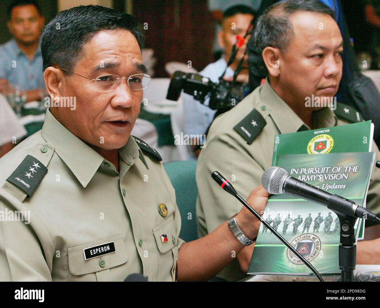 Philippine Army Chief Lt. Gen. Hermogenes Esperon shows a manual for ...