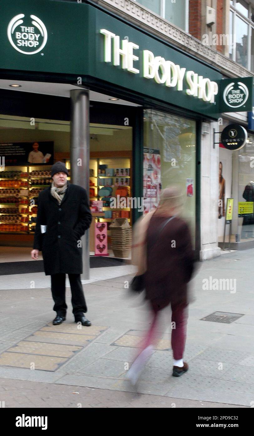 Pedestrians pass a Body Shop cosmetics store in London's Oxford Street ...