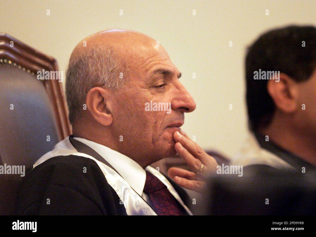 Chief judge Raouf Rashid Abdel-Rahman listens to testimony from Ali ...