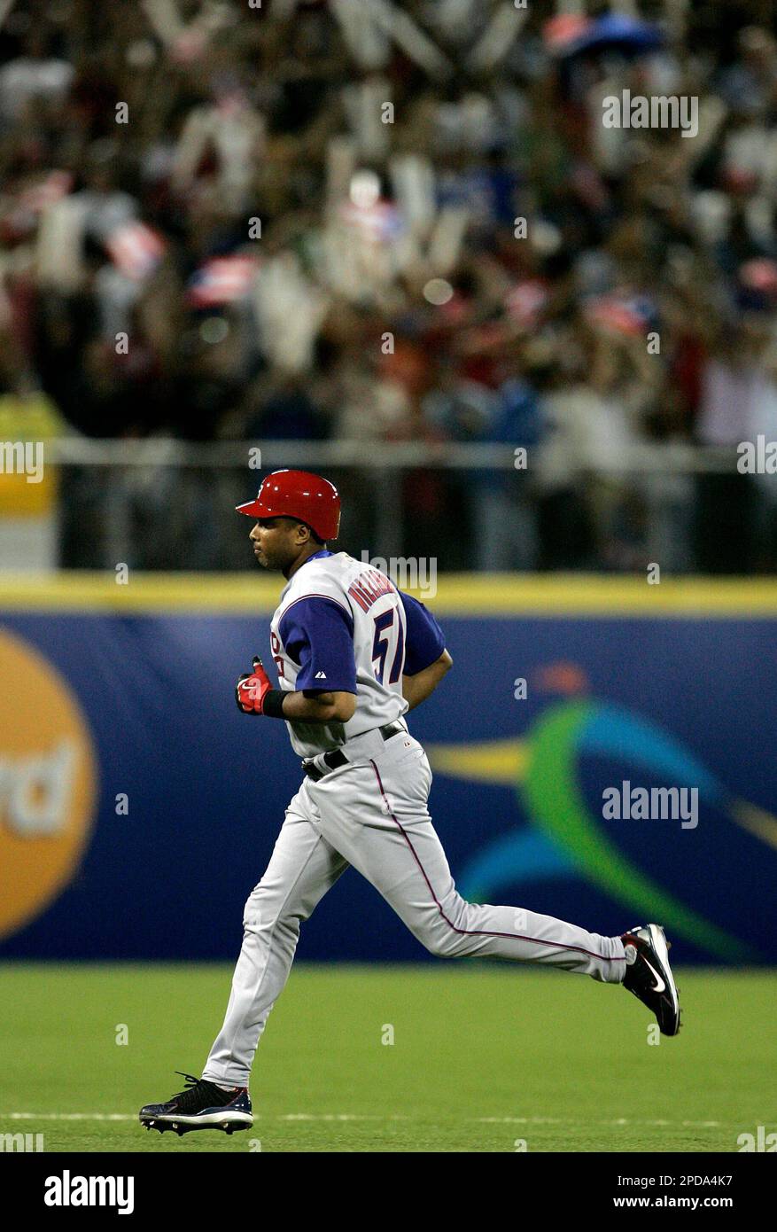 Team Puerto Rico's Bernie Williams runs the bases after hitting a 2-RBI ...