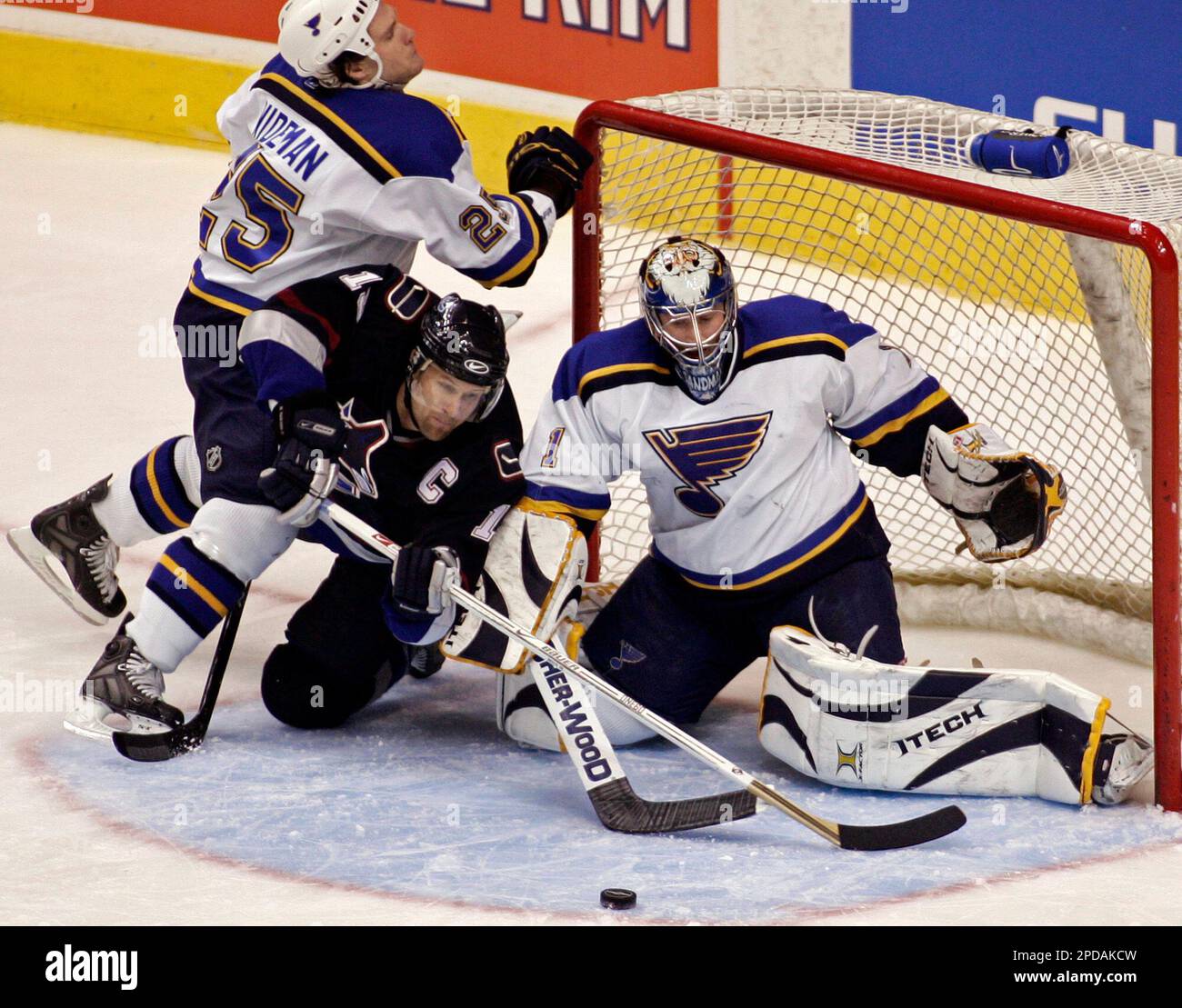 Vancouver Canucks' Markus Naslund, center, gets hit by St. Louis Blues ...