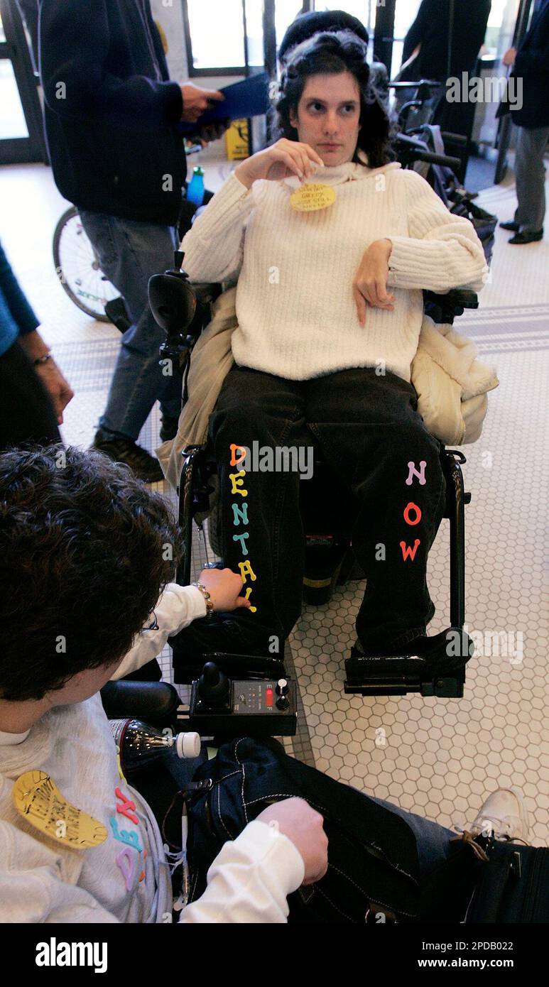 Sarah Watkins attaches letters spelling DENTAL NOW on the pants of ...