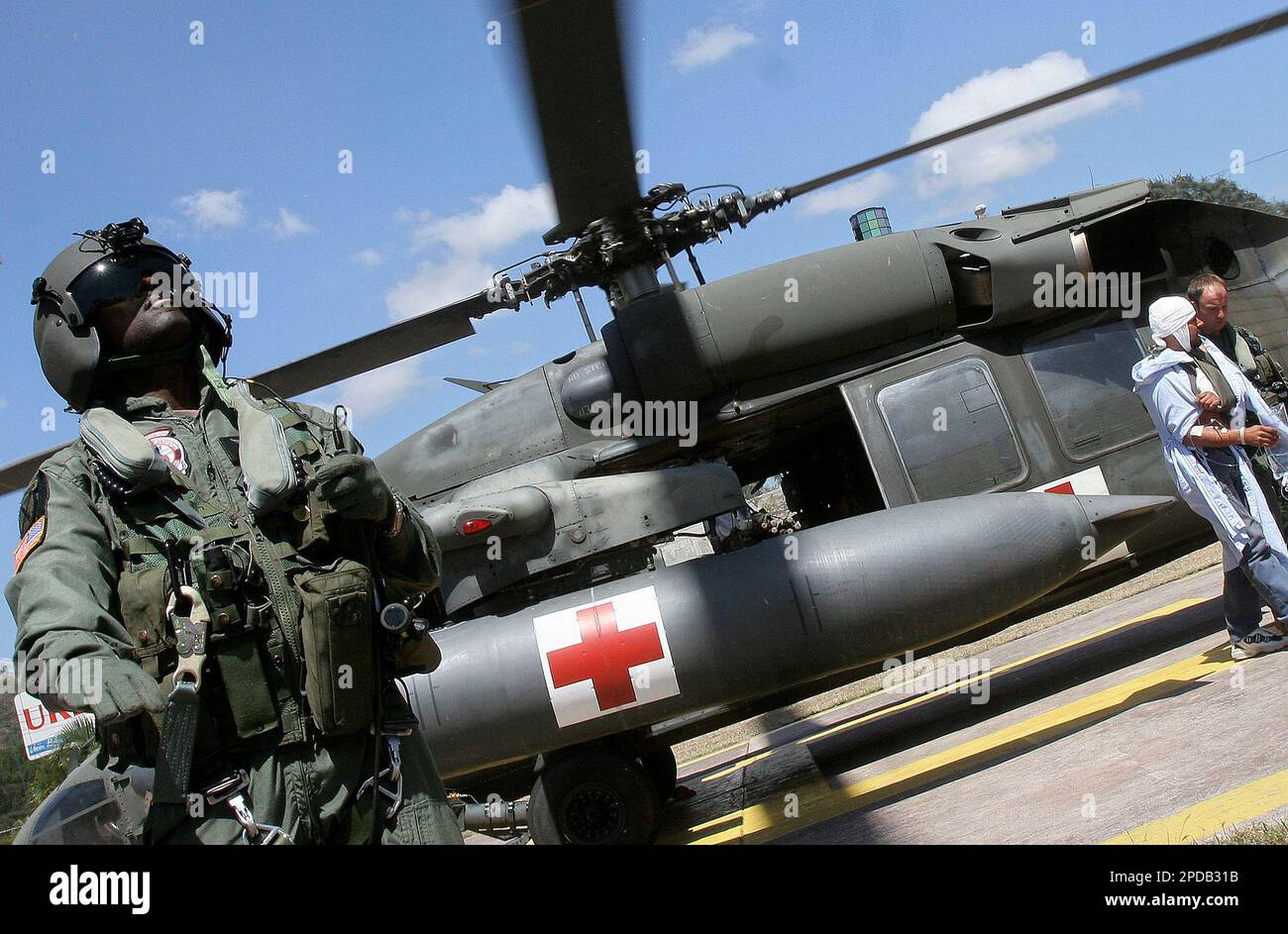 Crew members of an U.S. Army Blackhawk helicopter transport a wounded ...