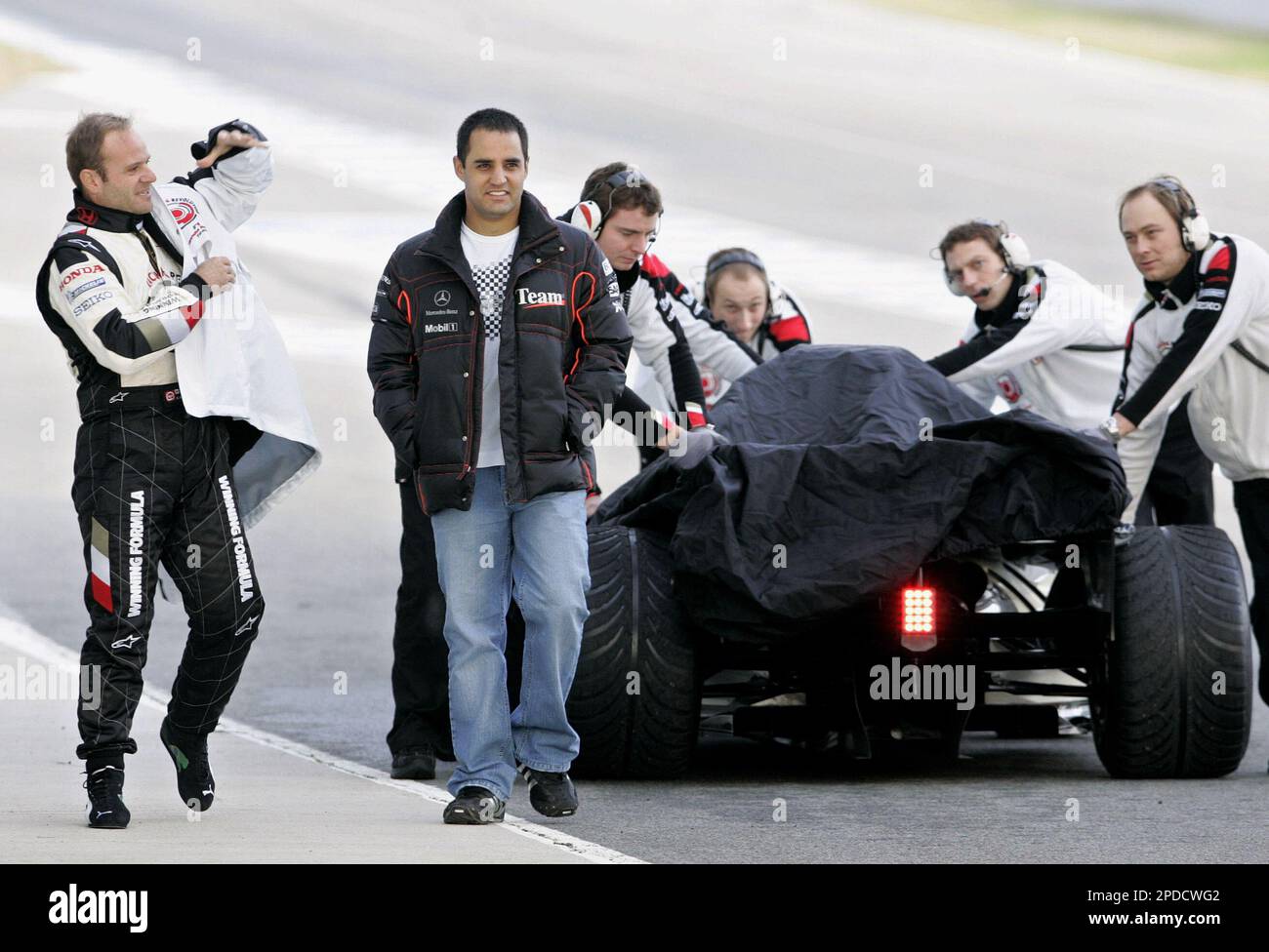 Brazilian driver Rubens Barrichello from Honda team, left, talks with ...