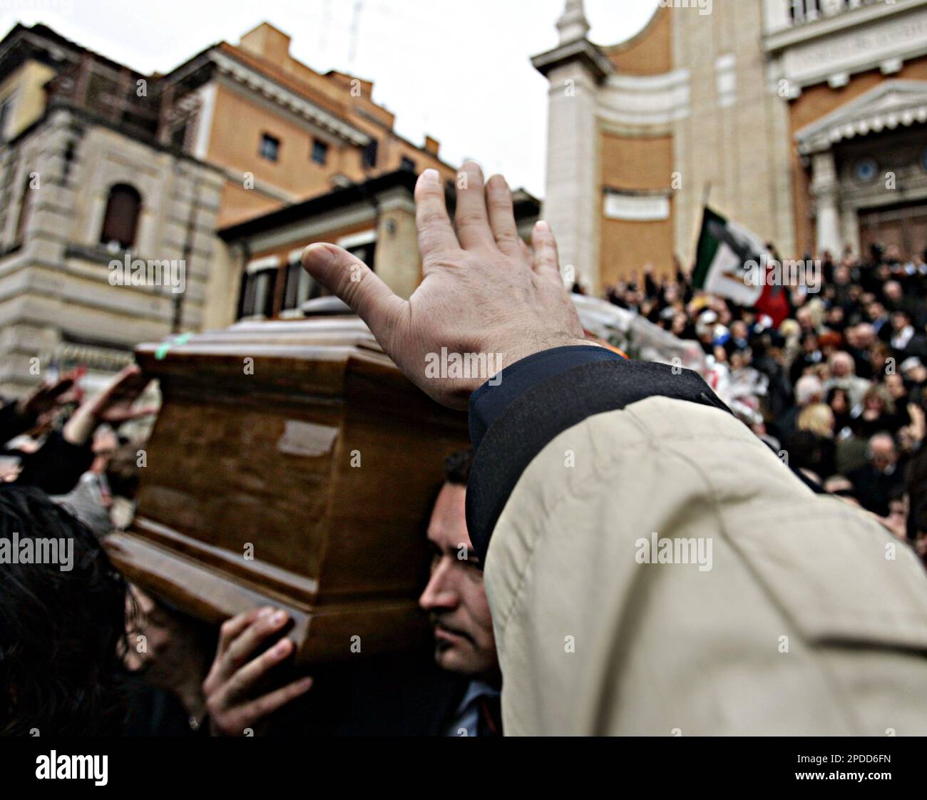 A man gives the fascist salute as the coffin of Romano Mussolin is ...