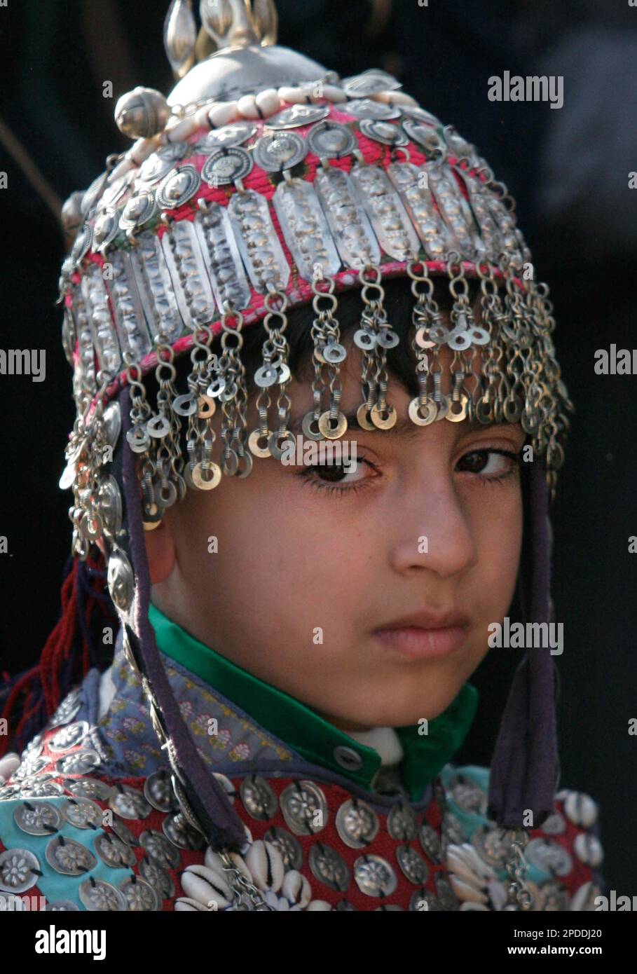 A young Iraqi boy wears a traditional costume during the first day of ...