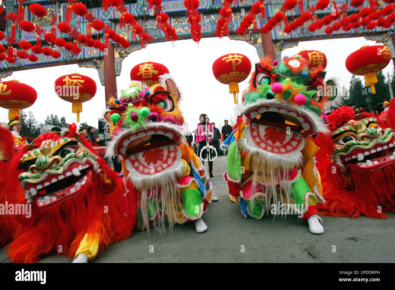 A musician waits her turn to play as Chinese performers dressed in ...