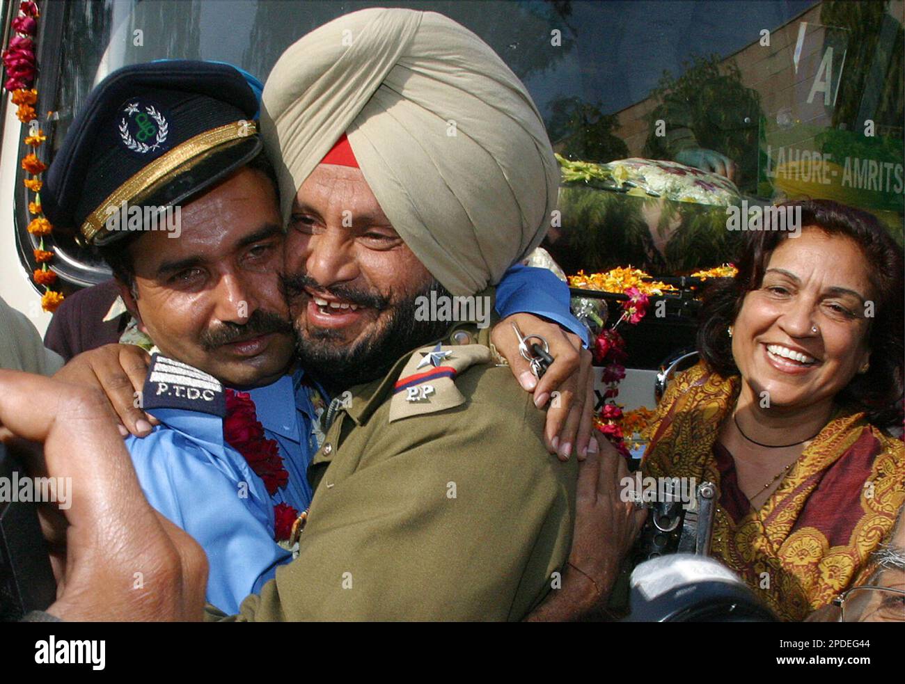 An unidentified Indian police officer, right, hugs Pakistani bus driver ...