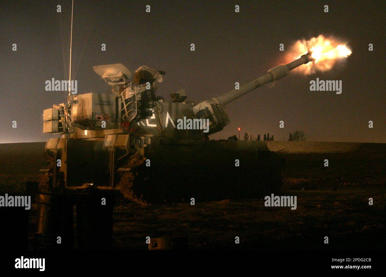 An Israeli Army mobile artillery piece fires towards a target in Gaza ...
