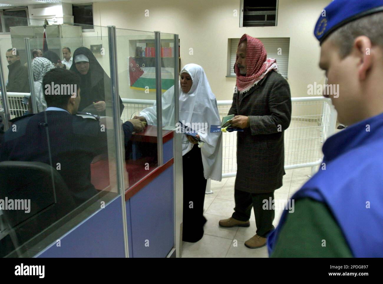 An European Union observer, right, looks on as a Palestinian police ...