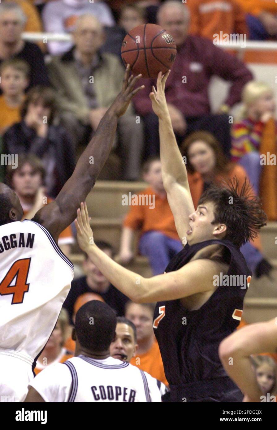 Oklahoma State forward Mario Boggan, left, deflects a shot by Mercer ...