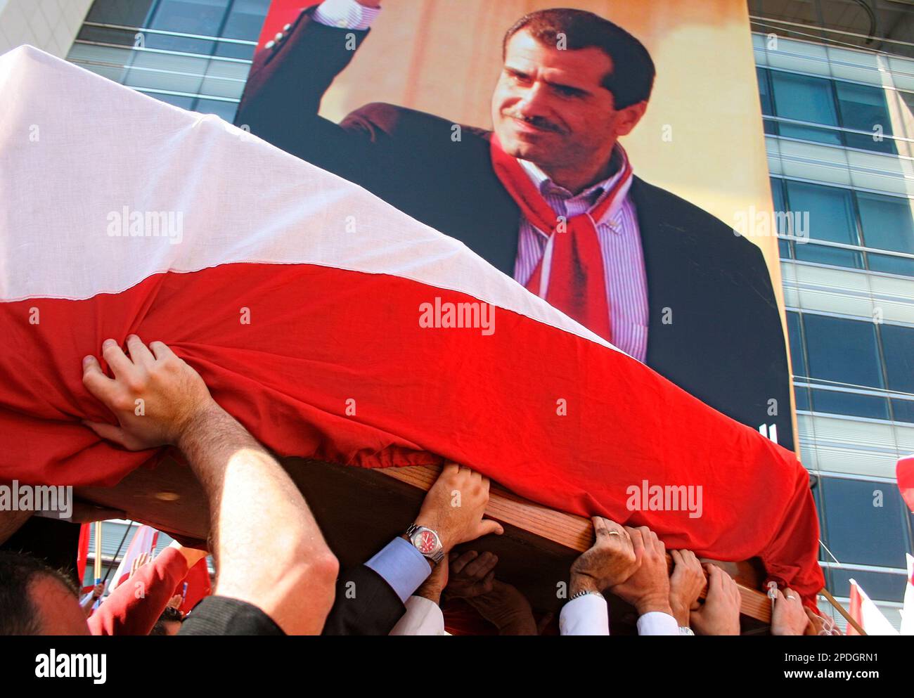 Lebanese mourners carry the coffin of slain anti-Syrian journalist and ...