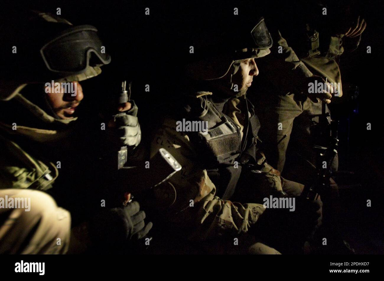 Iraqi soldiers sit in the back of a U.S. Marine humvee before a night ...