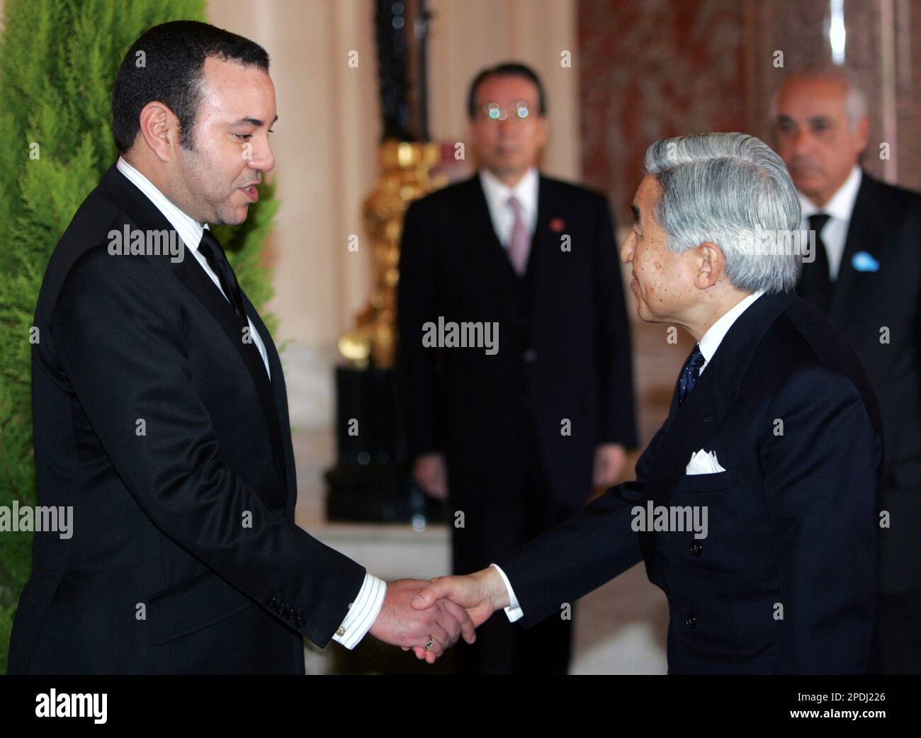 Moroccan King Mohammed VI, left, is greeted by Japanese Emperor Akihito ...