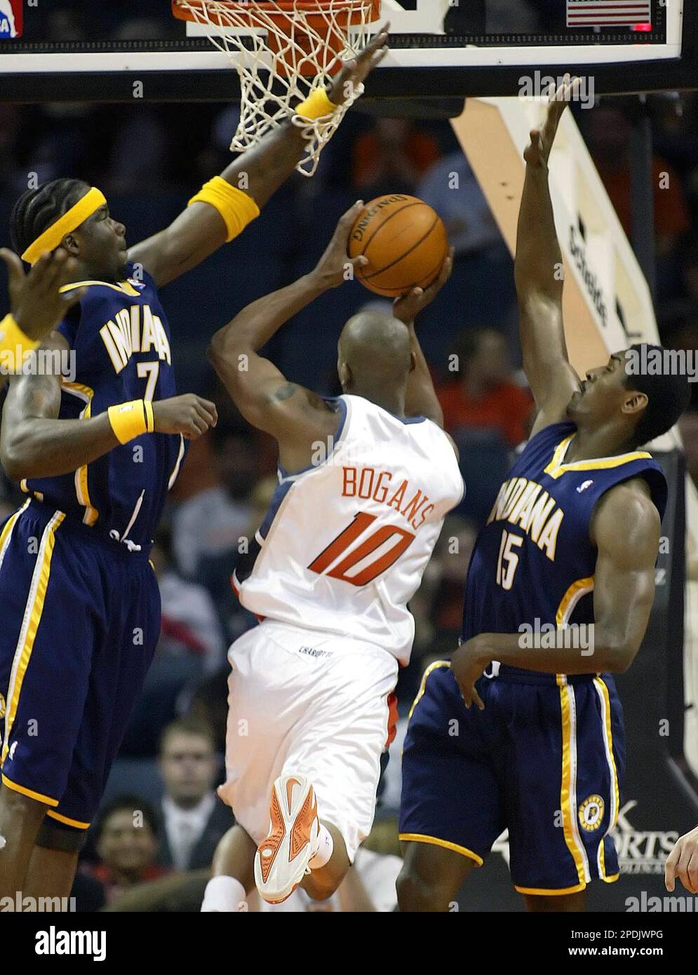 Charlotte Bobcats' Keith Bogans (10) drives between Indiana Pacers ...