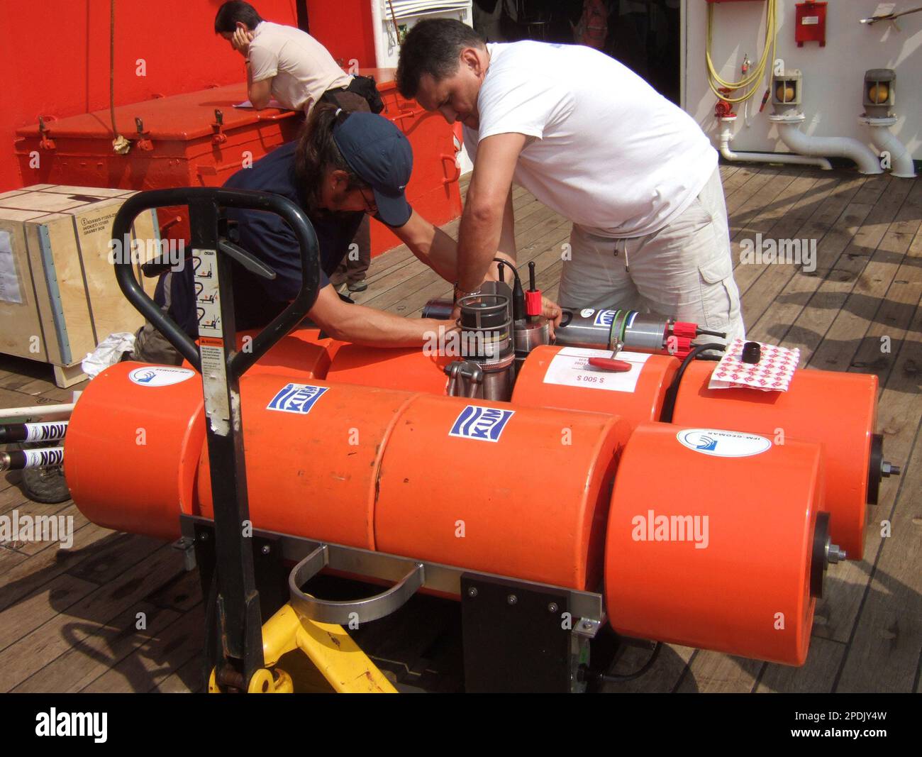 Technicians set up ocean bottom seismometer which will be part of a ...