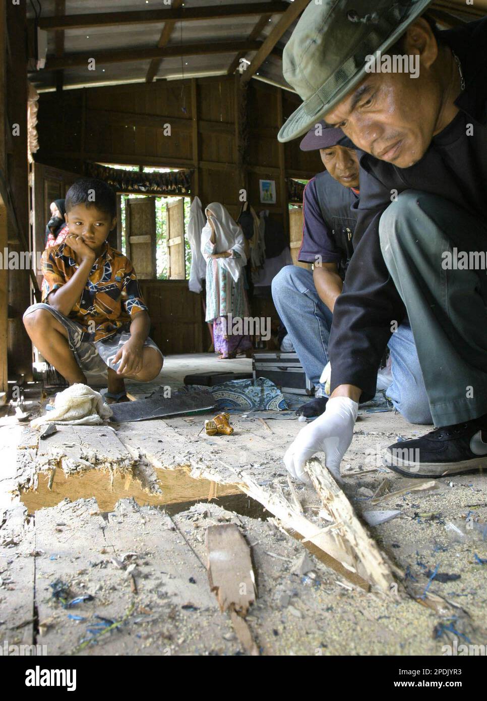 Thai soldiers examine the floor at a house where Muslim militants made ...