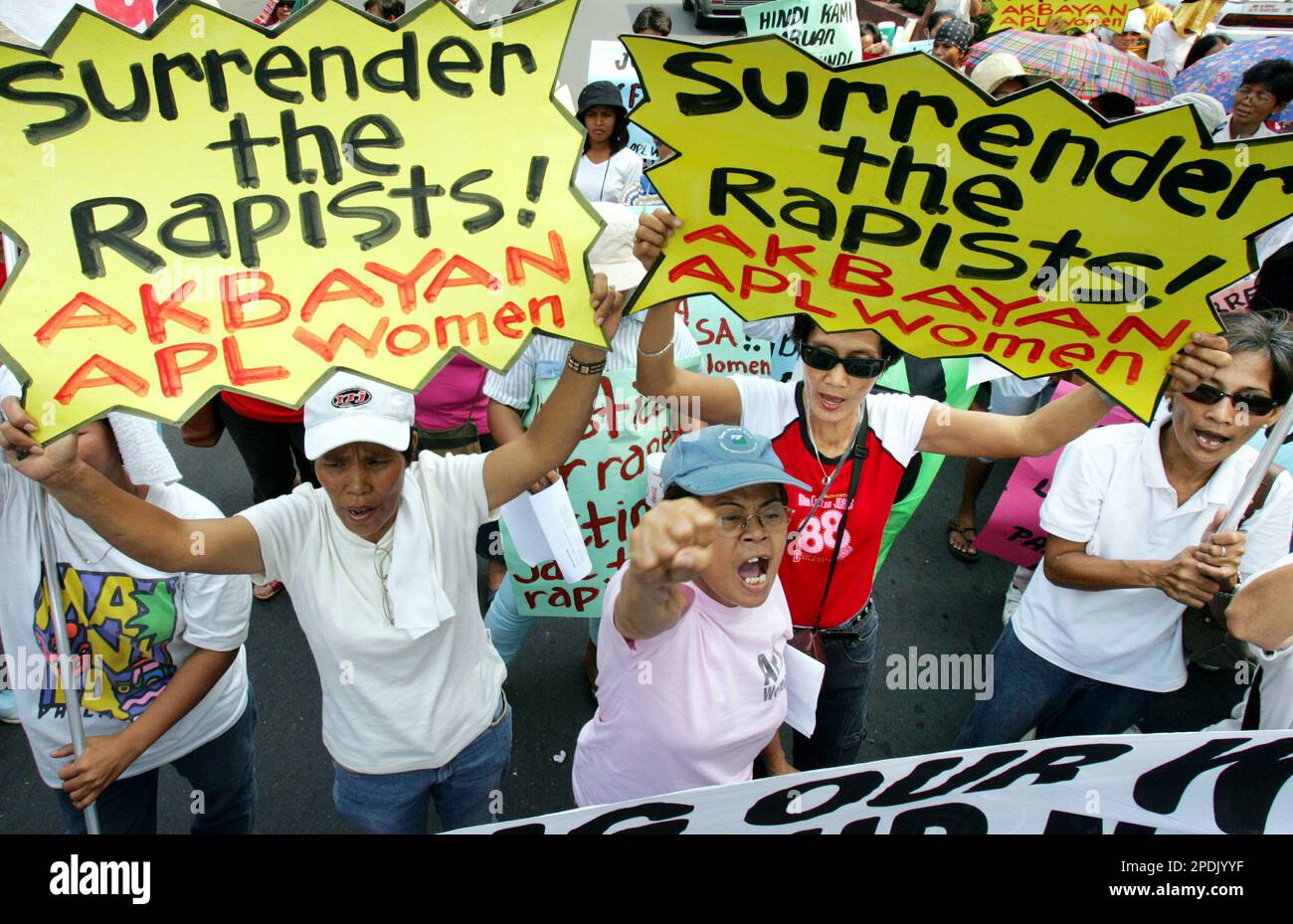 Angry female protesters display their placards as they shout slogans ...