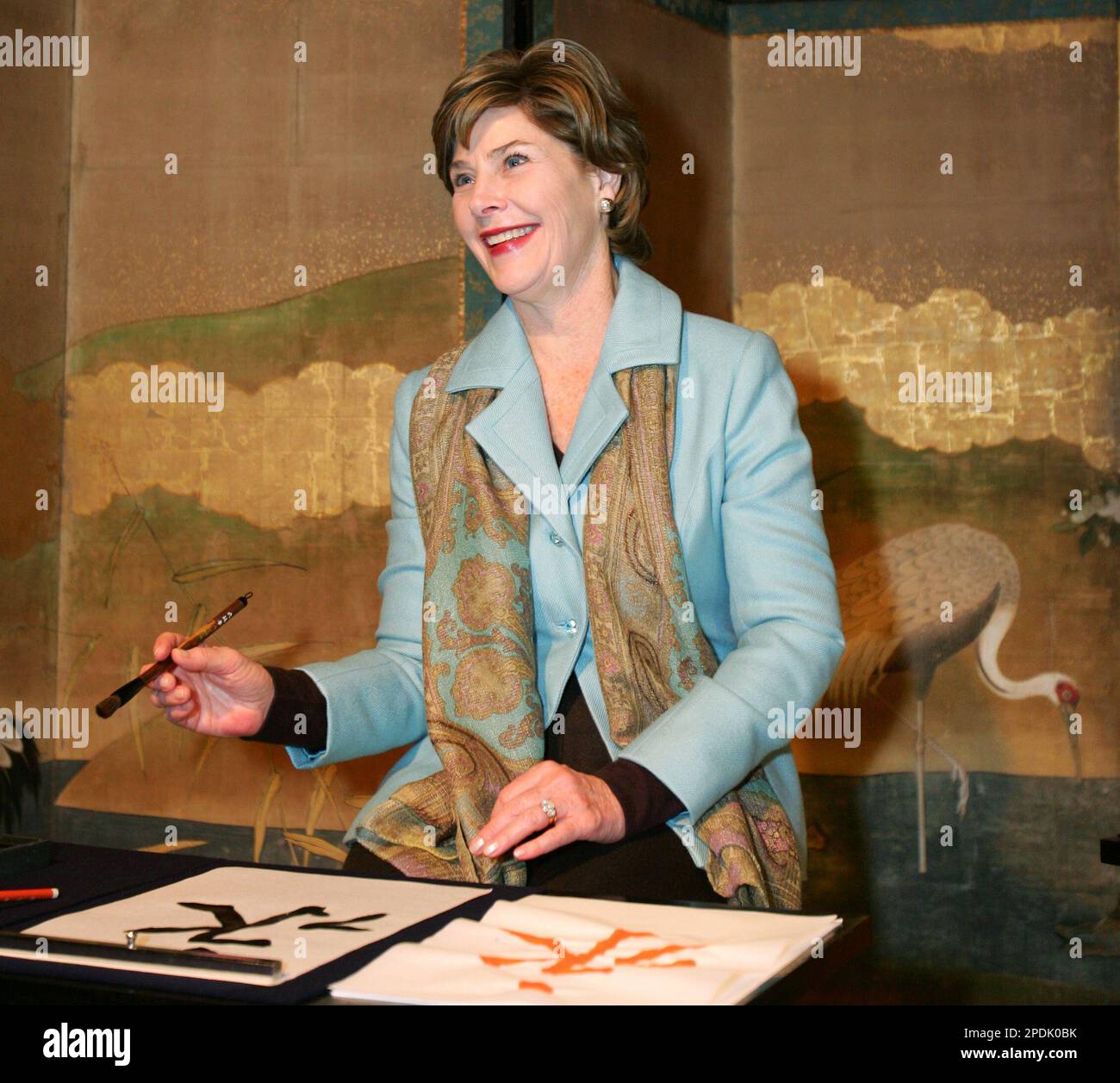 U.S. First Lady Laura Bush reacts during a calligraphy workshop inside ...