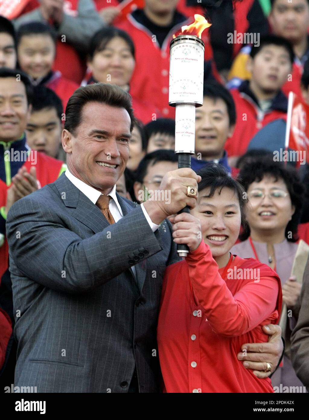 California Gov. Arnold Schwarzenegger, left, holds the Special Olympics torch after receiving it ...