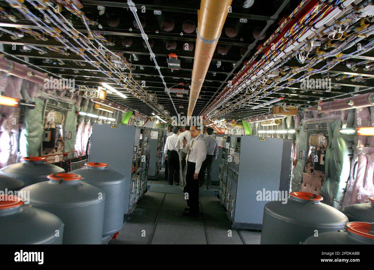 A man takes a photo with his mobile phone during a tour of the interior ...