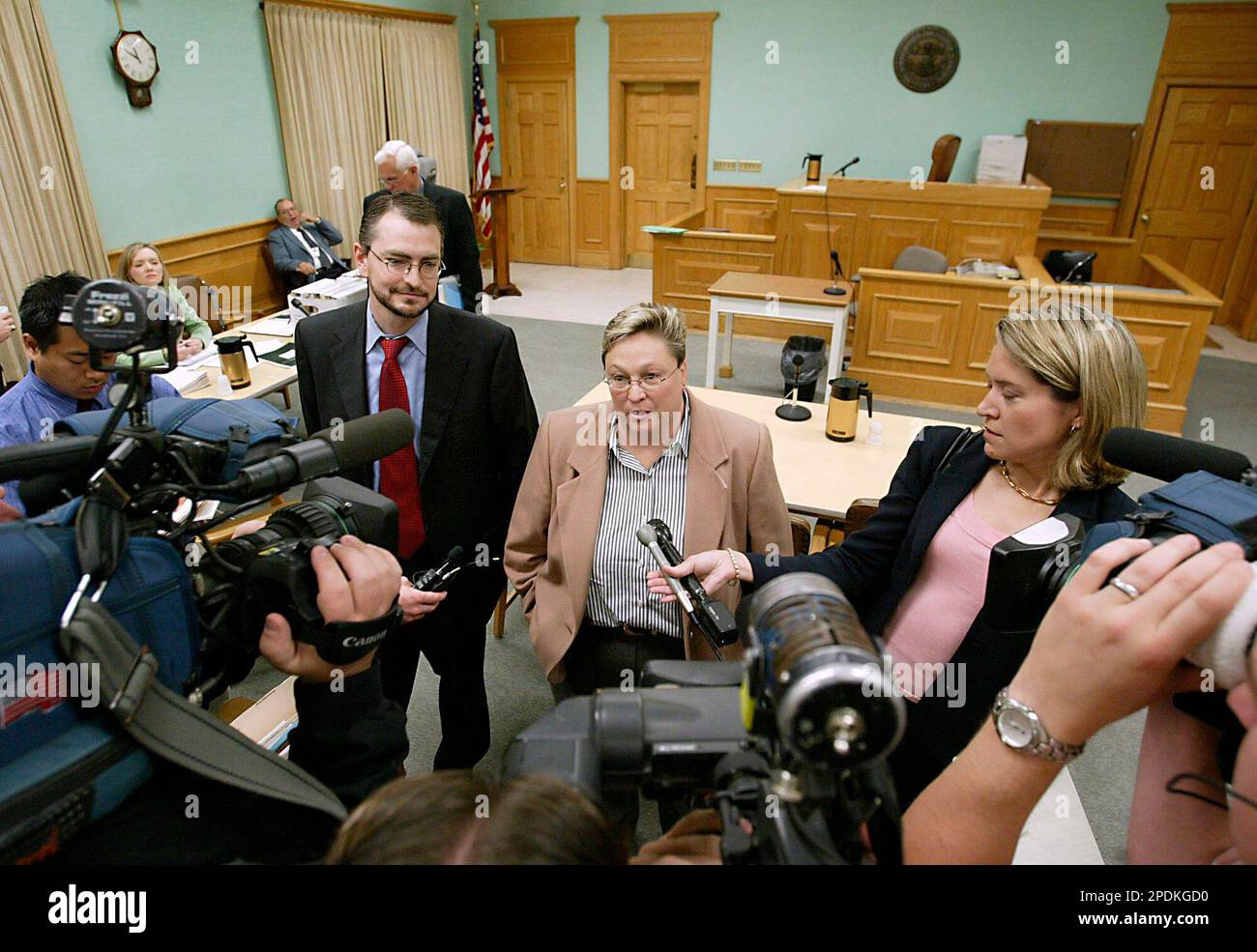 Defense atttorney Cynthia Schemel, center, answers questions from ...