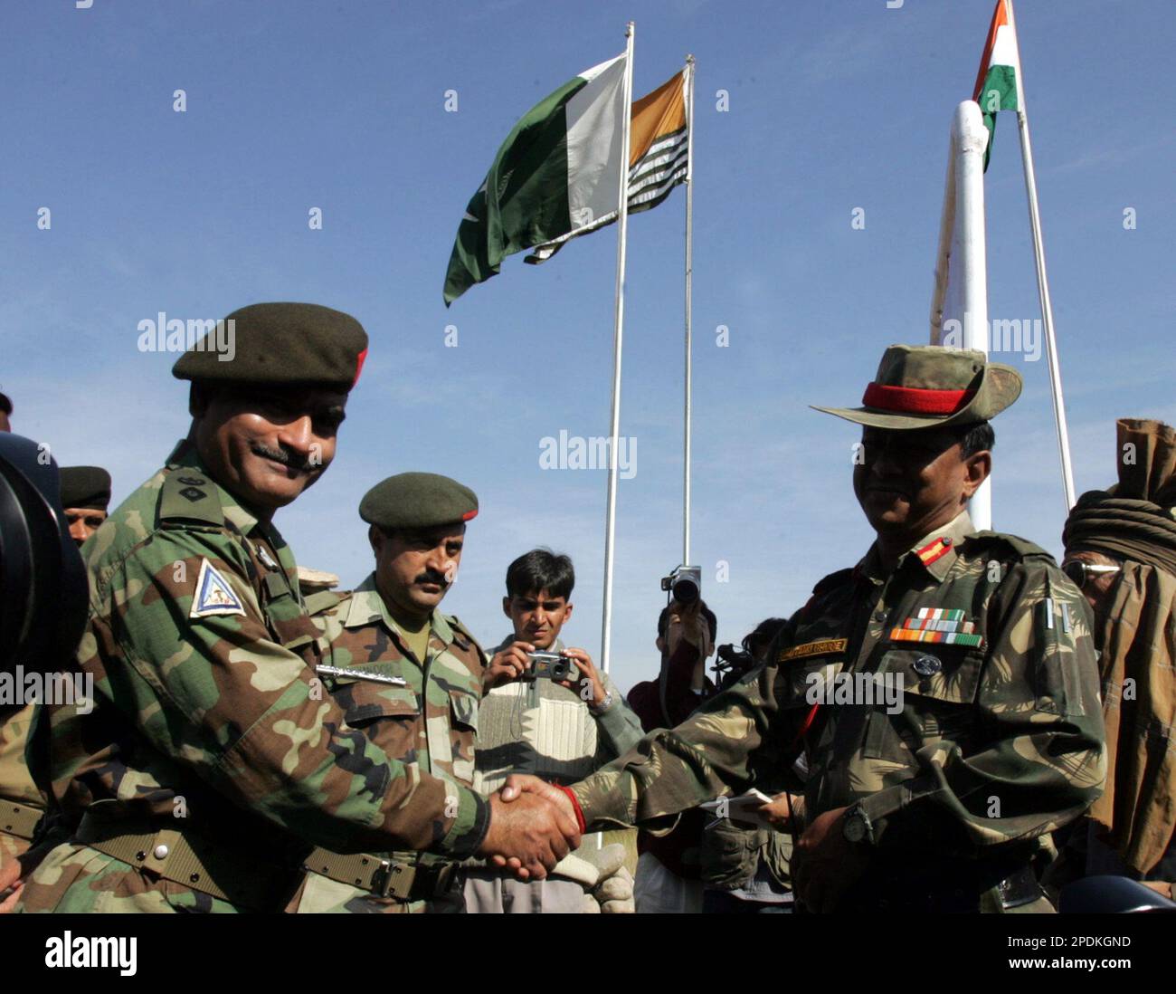 Pakistan army's Lt. Col. Ali Khan, left, shakes hands with Indian army ...