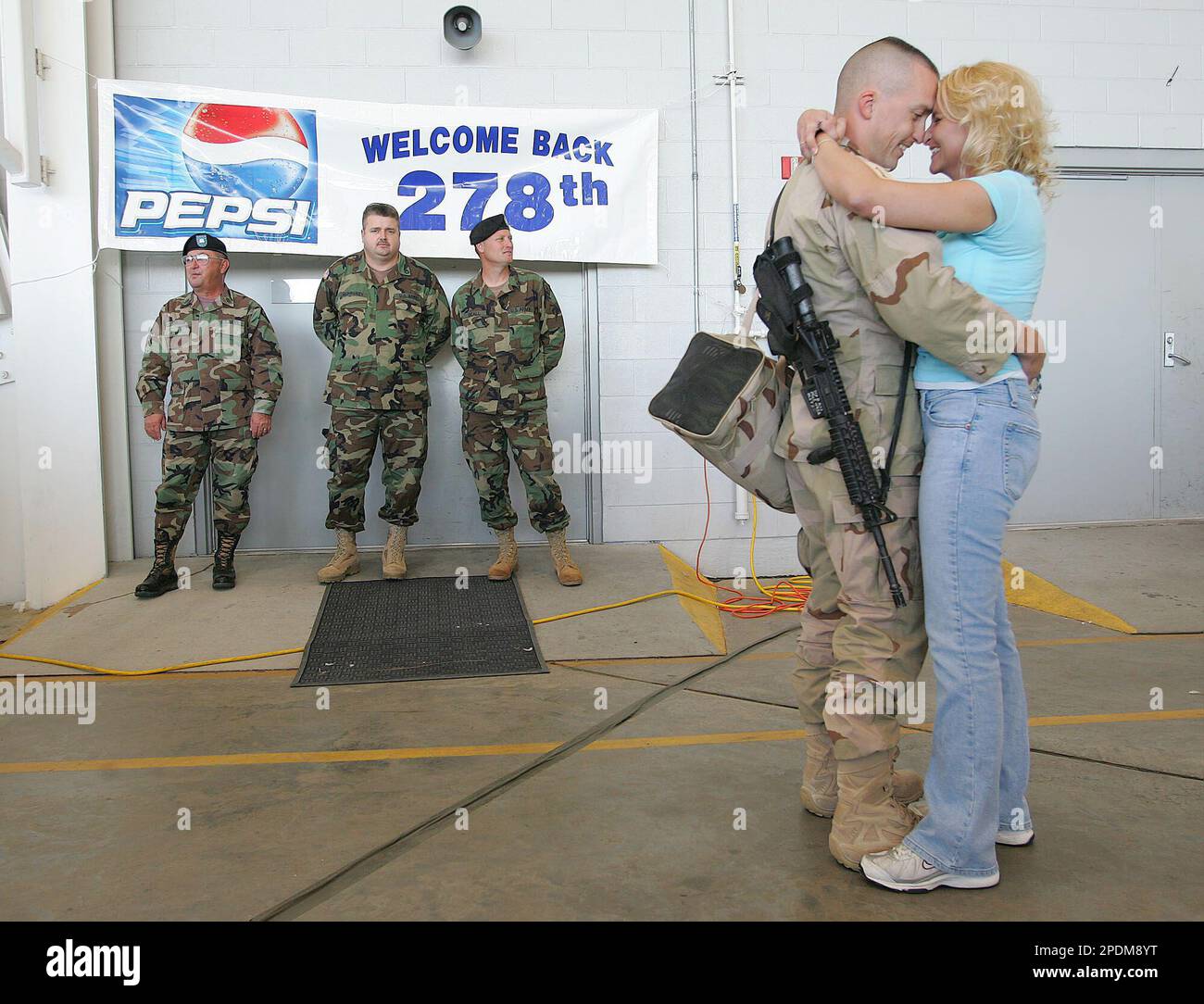 Sgt. Jason McClard, of Lafayette, Tenn., gets a hug from his wife ...