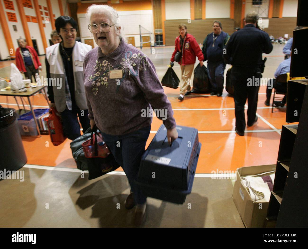 Red Cross volunteer Annette Hawko, front, assists Taunton, Mass ...