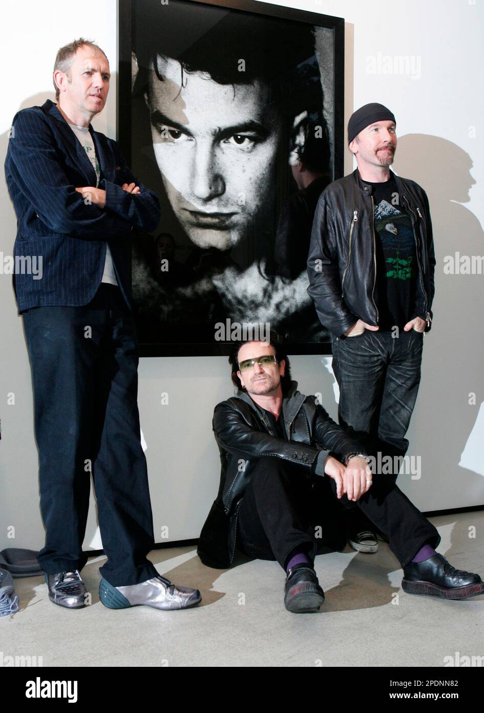 U2's Bono, seated, and guitarist The Edge, right, pose with ...