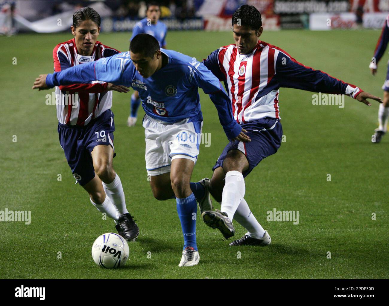 Cruz Azul's Javier Orozco, center, battles for control of the ball with ...