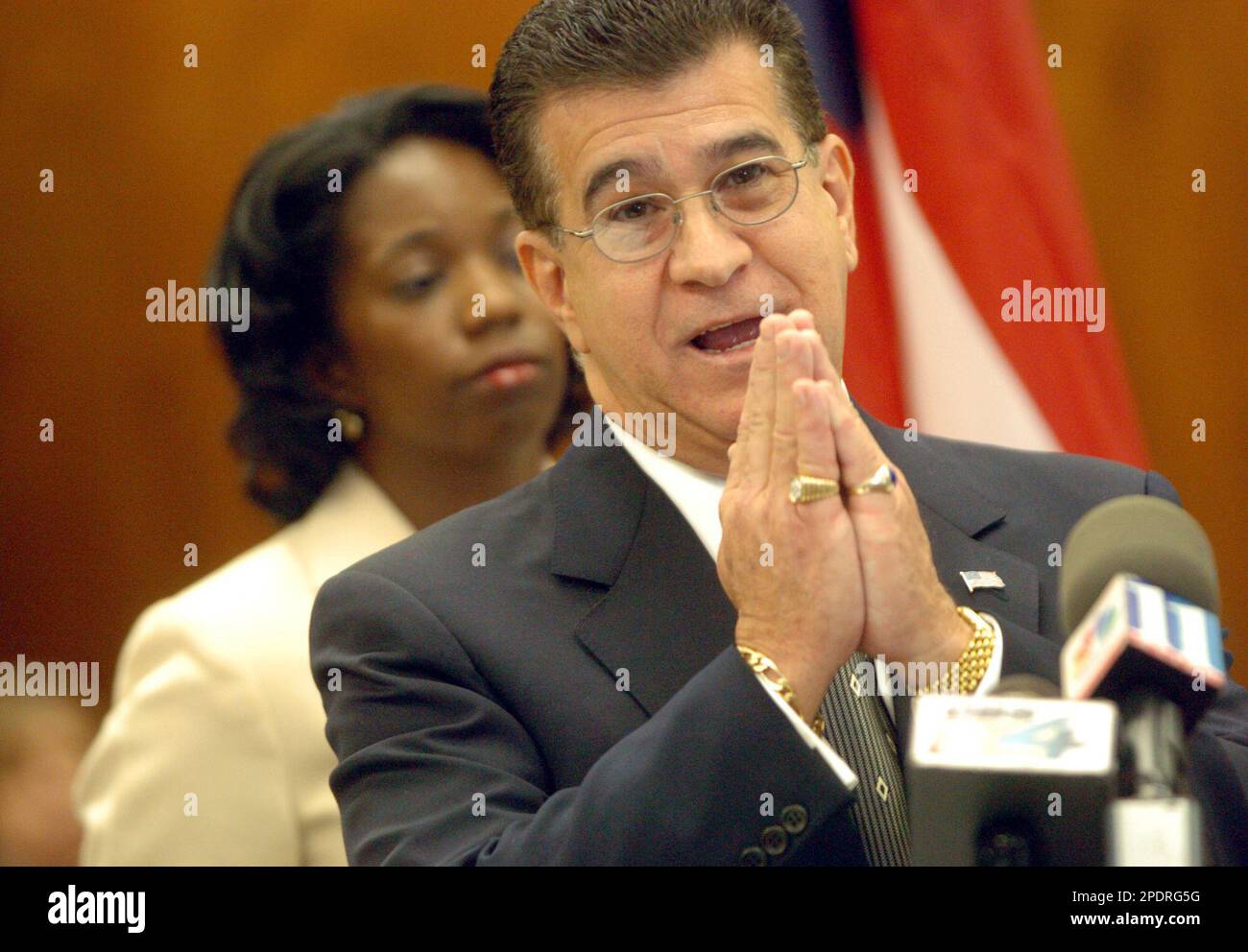 Luis Melendi is flanked by Dekalb District Attorney Gewn Keyes, left ...