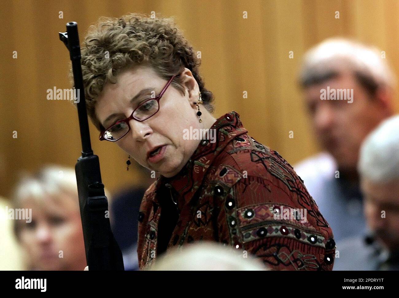 Wisconsin Attorney General Peg Lautenschlager holds up a gun as she ...
