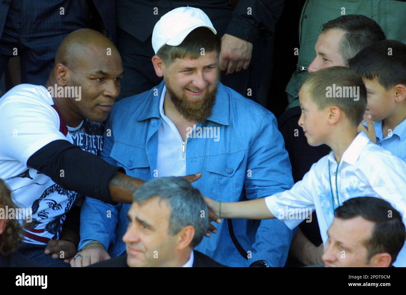 Former world heavyweight boxing champion Mike Tyson, left, is greeted ...