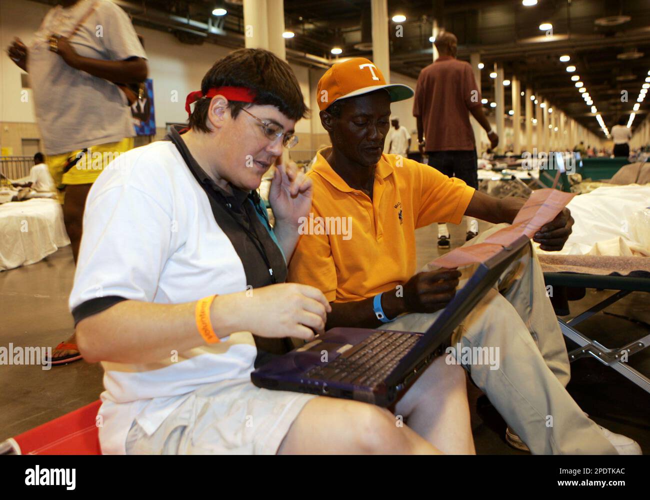 Anne Ritchie, left, of Houston, uses a laptop computer to write a ...