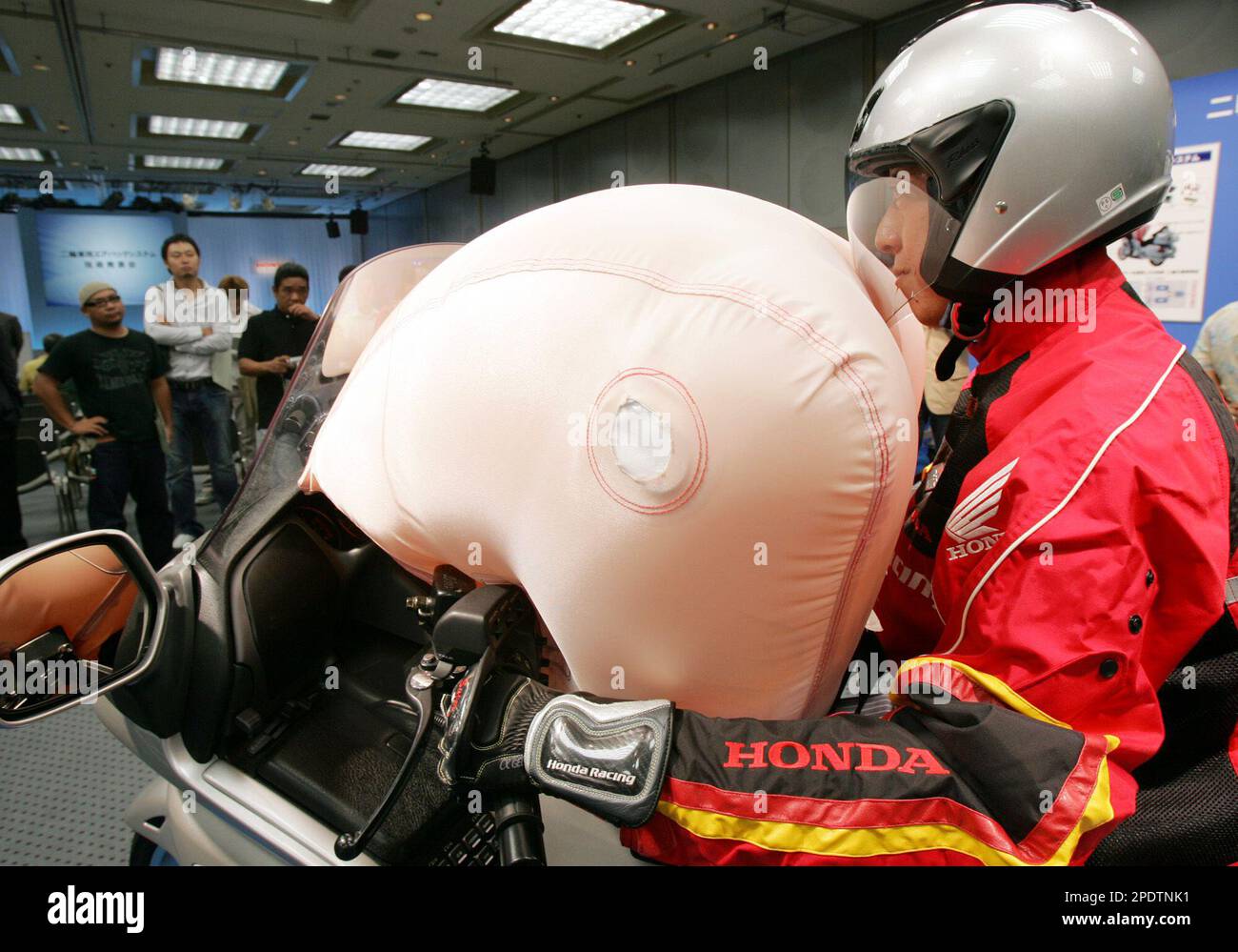 Honda Motor Co., Ltd. staff Takeshi Kuroe poses on Honda's new Gold ...