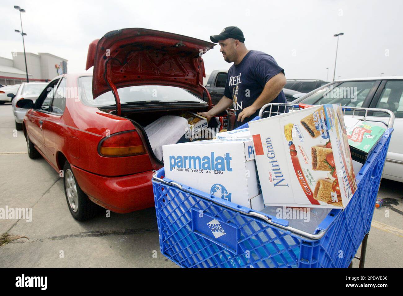 Gene Waltman of Pass Christian, Miss., rushes to load supplies Thursday ...