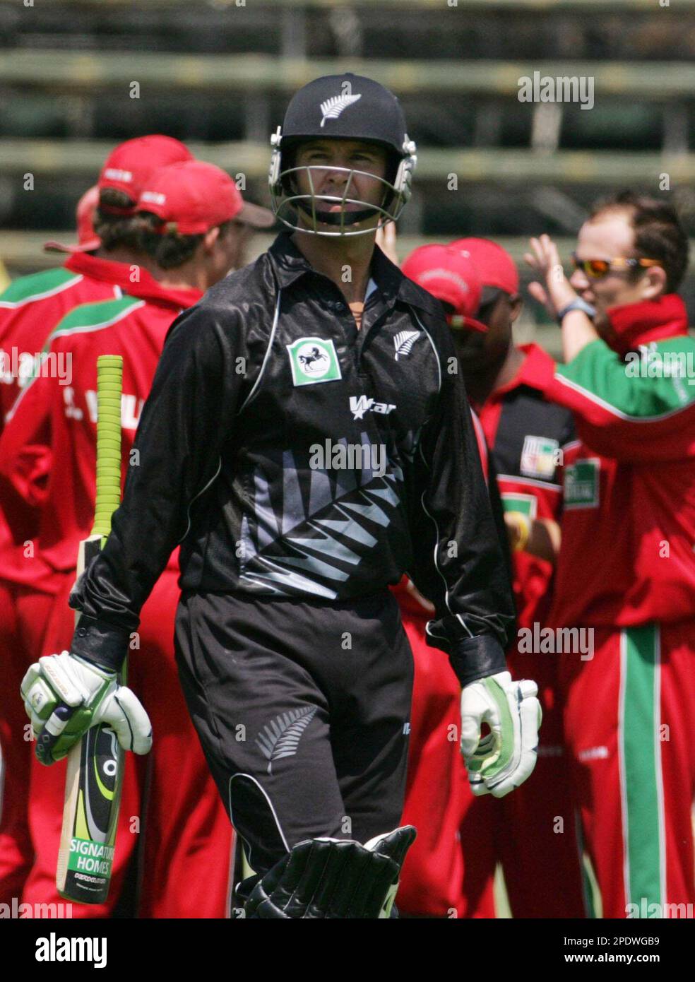 New Zealand's batsman Nathan Astle leaves the crease as Zimbabwe's ...