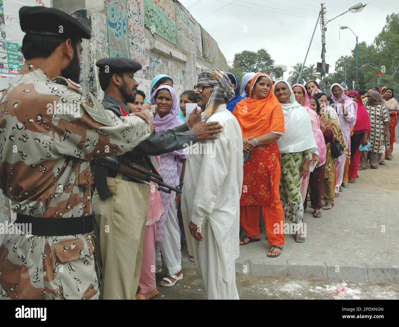 Pakistan's para-military officer, left, and police officer, second from ...