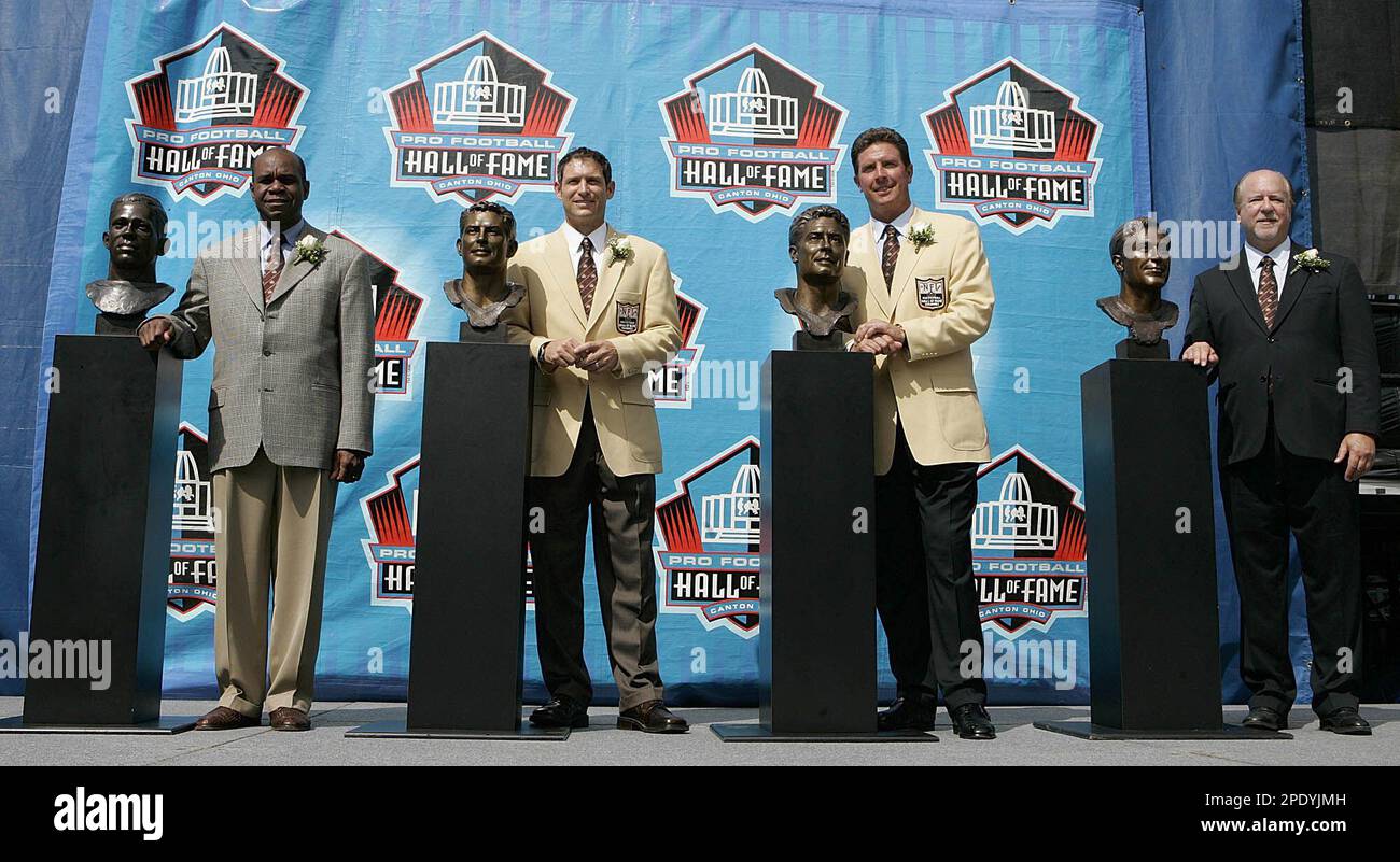 Steven Towns, left, stands next to the bust of Fritz Pollard and David ...