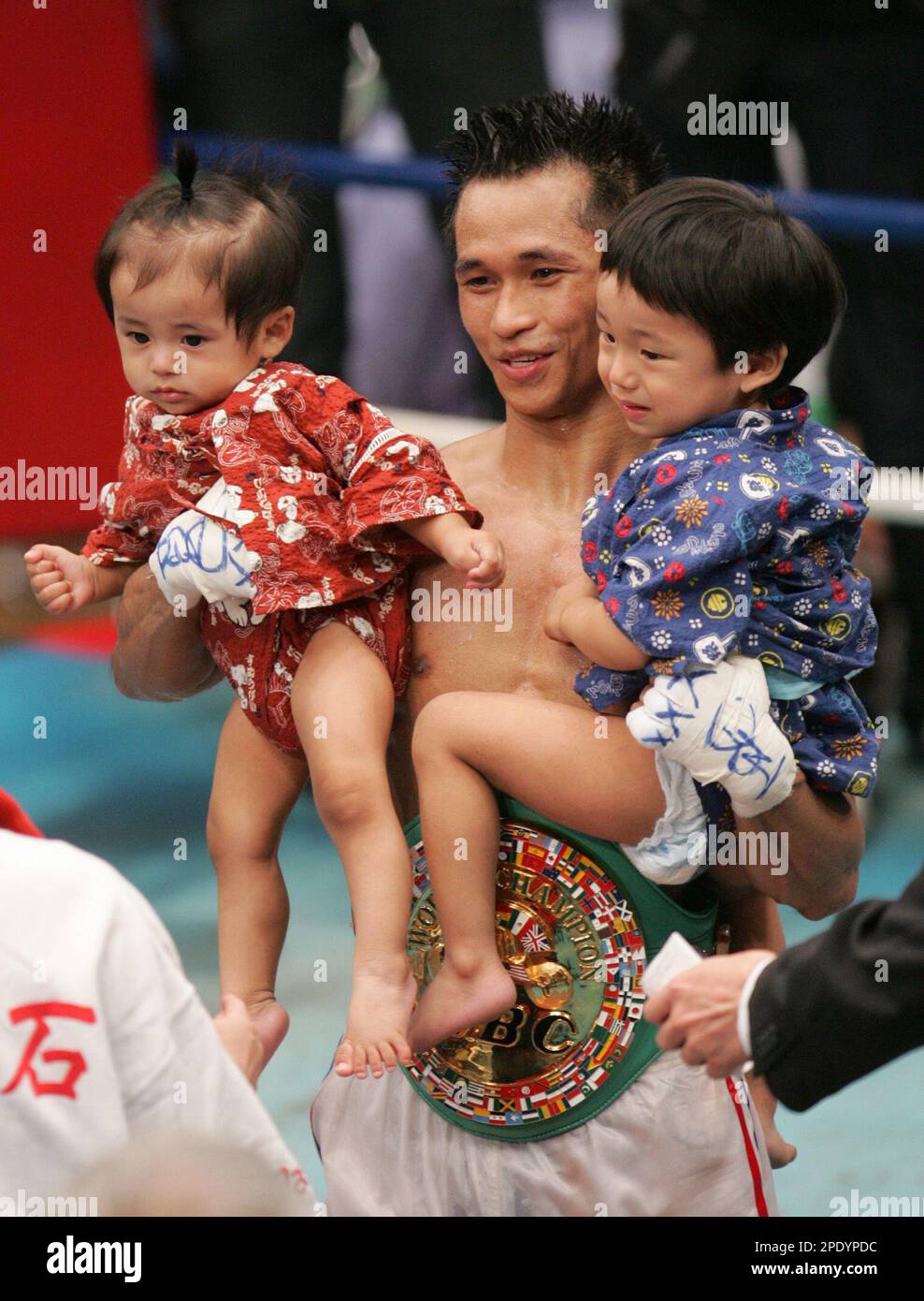 Challenger Eagle Kyowa holds his two children, Ryuto, left, and Ryuki ...