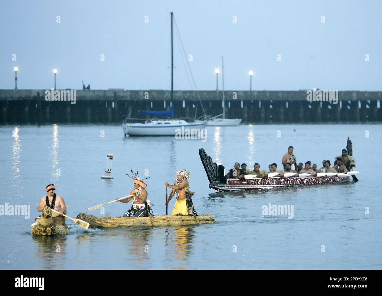 A large canoe of Maori warriors from New Zealand is led toward shore at ...