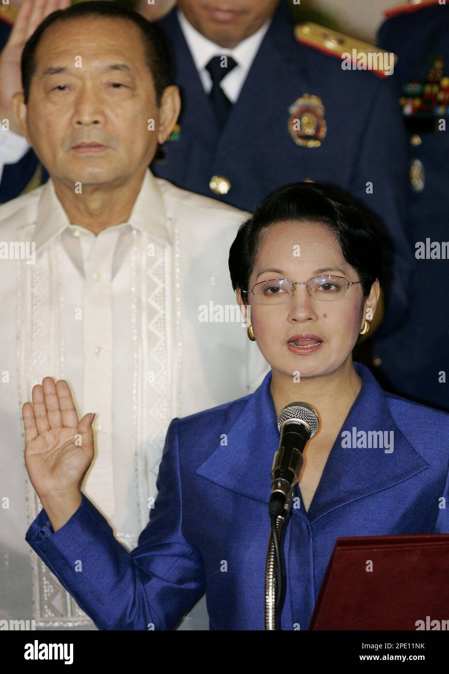 Philippine President Gloria Macapagal Arroyo, right, swears in newly ...