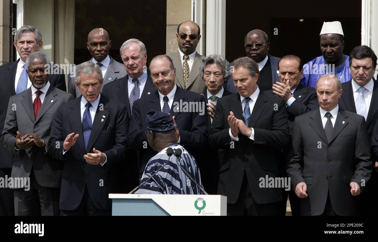 G8, African and other leaders applaud Nigerian President Olusegun Obasanjo, front center, after ...