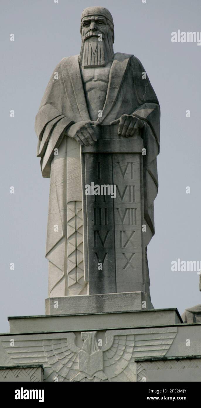 A statue of Moses holding the Ten Commandments looks down from the roof ...